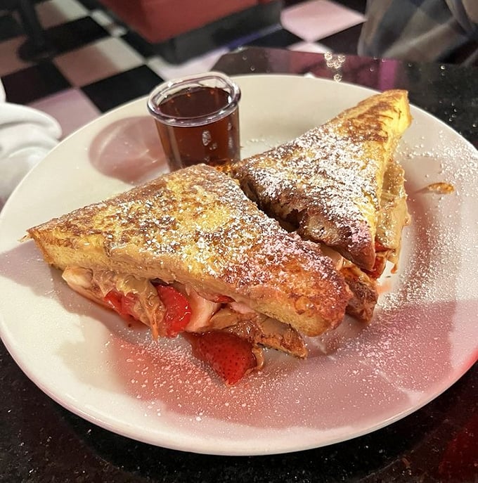 French toast stuffed with strawberries and cream cheese, dusted with powdered sugar—because sometimes breakfast should double as dessert and therapy.