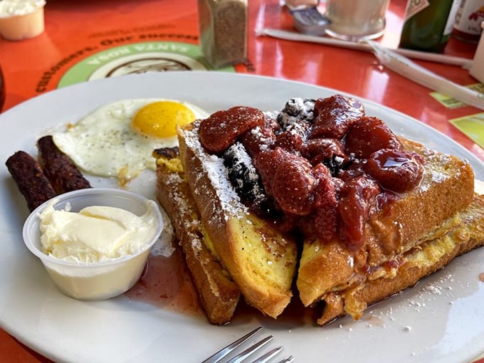 The stuffed French toast doesn't just arrive—it makes an entrance, crowned with berries and ready for its close-up.