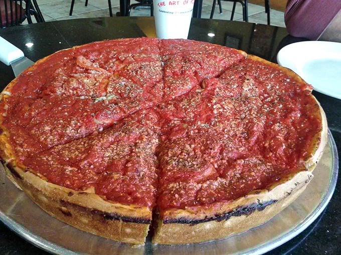 Chicago-style deep dish in all its glory – that magnificent wall of crust containing a lake of bright tomato sauce that demands both fork and respect.