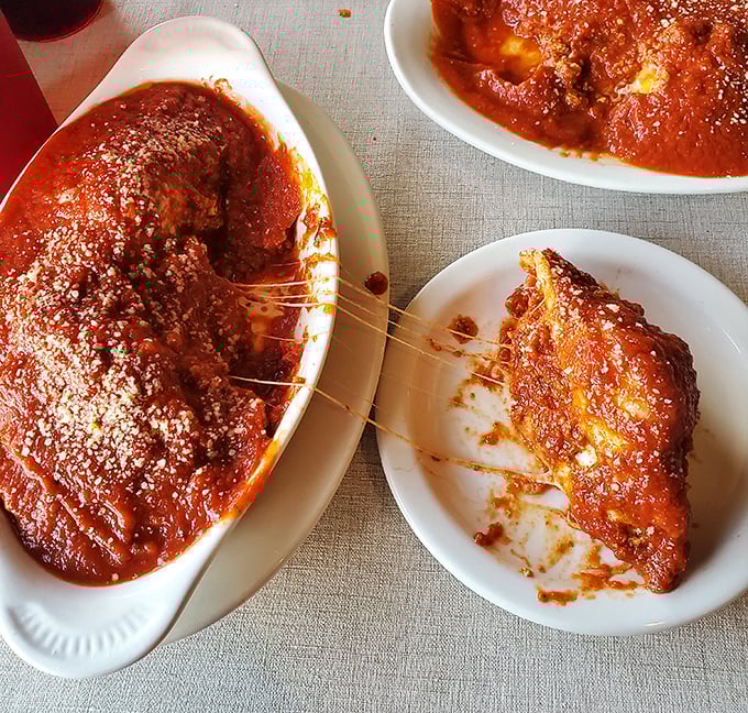 The stuffed shells arrive like little boats sailing on a sea of marinara, with cheese stretching between plate and fork in that perfect Instagram-worthy moment.