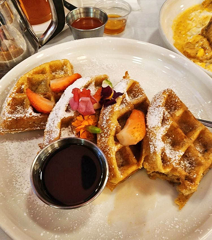 These sweet potato waffles don't just sit on the plate—they perform. The powdered sugar dusting is like morning snow on delicious terrain.