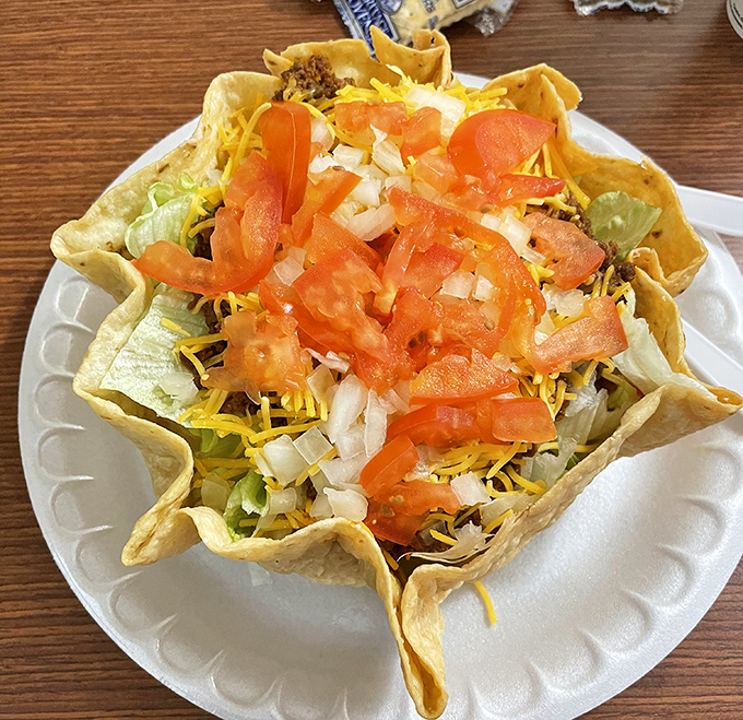 This isn't just a taco salad; it's an edible fortress protecting a treasure of seasoned beef, cheese, and fresh veggies. 