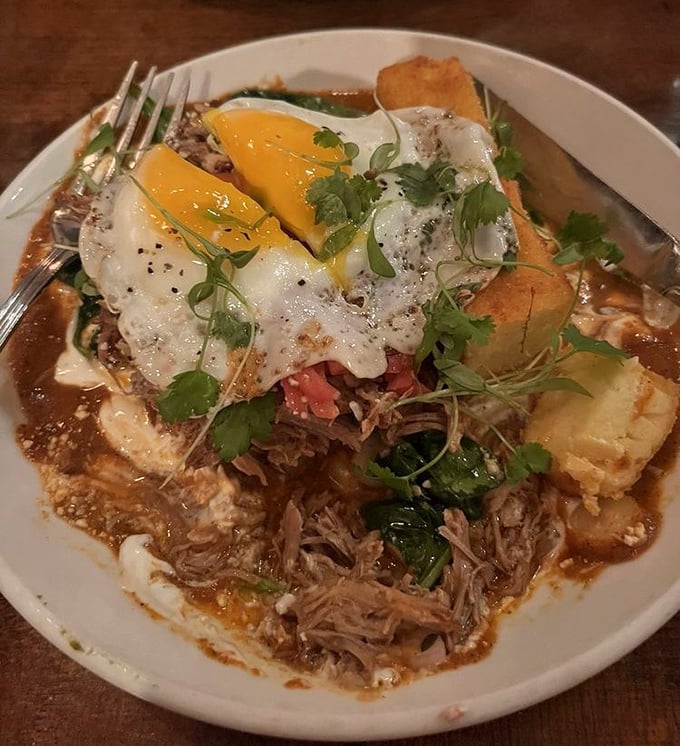 Breakfast meets dinner in this tamale topped with sunny eggs—proof that some of life's greatest pleasures come wrapped in corn husks.