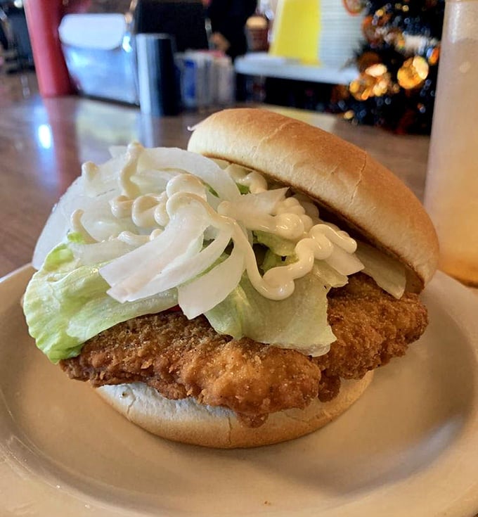 The breaded tenderloin—Indiana's unofficial state sandwich—extends gloriously beyond its bun boundaries, a crispy-golden testament to Hoosier hospitality on a plate.