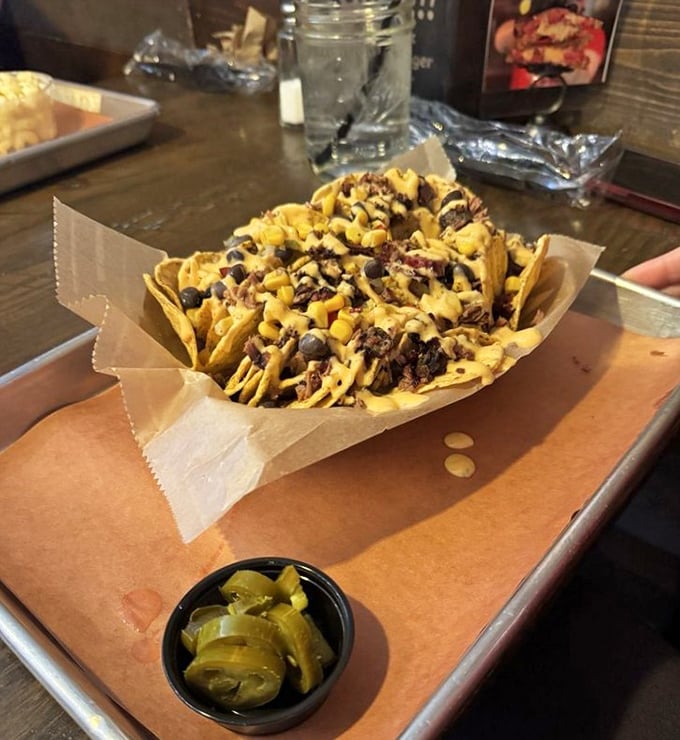 These loaded nachos arrive looking like edible architecture – Frank Lloyd Wright would approve of this delicious chaos.