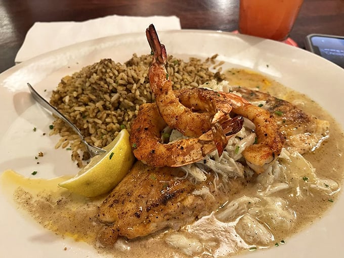 Texas Redfish Pontchartrain swimming in creamy sauce with plump shrimp standing guard—proof that fish can indeed fly to flavor heaven.