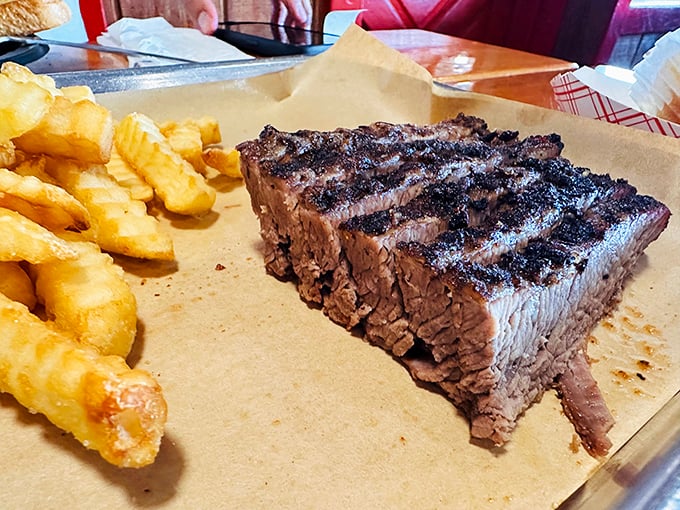 Texas brisket with that telltale smoke ring—barbecue's equivalent of Olympic gold. The crinkle-cut fries are just there for moral support.