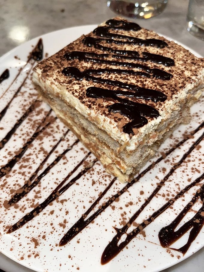 Tiramisu that would make your Italian grandmother weep with joy. Those chocolate drizzles aren't just decoration – they're pathways to happiness.