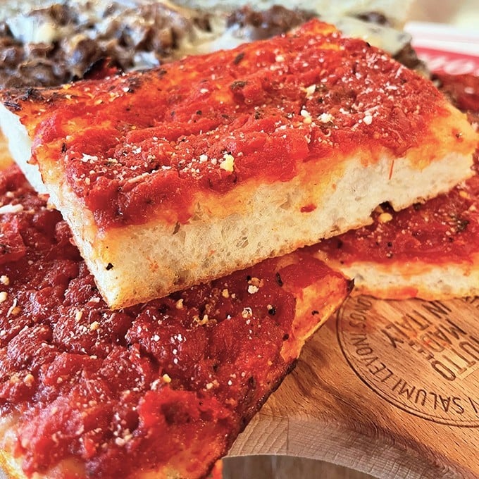Tomato pie that makes you question everything you thought you knew about pizza. The simplicity is the genius—just perfect crust, vibrant sauce, and a dusting of cheese.