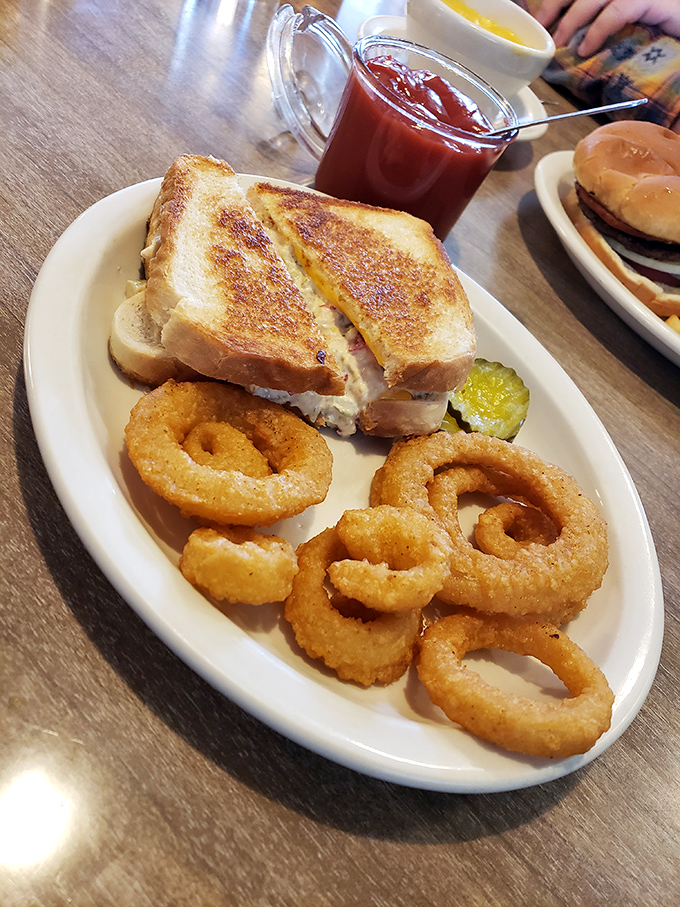 The tuna melt and onion rings combo—proof that simplicity, when executed perfectly, beats culinary gymnastics every time. That pickle knows its role.