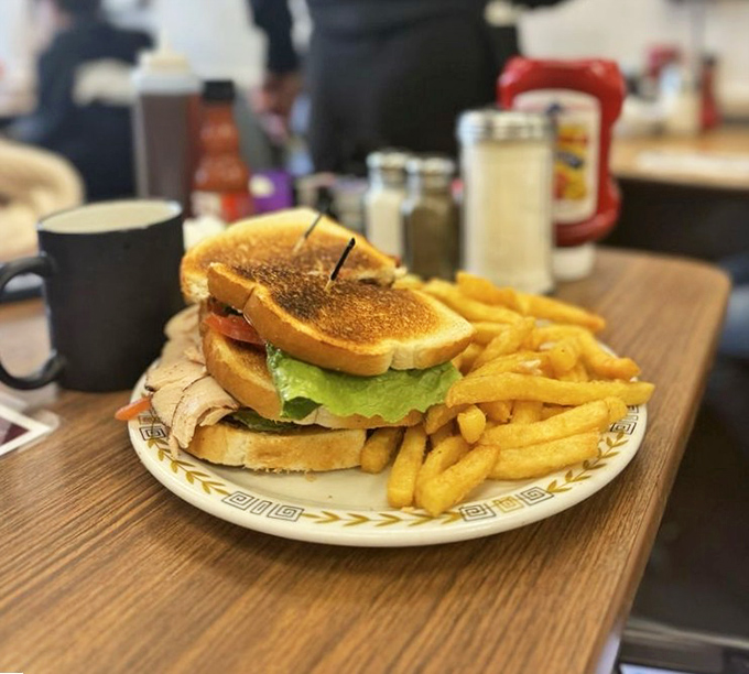 This towering turkey club proves that sometimes the best sandwiches require architectural engineering degrees.