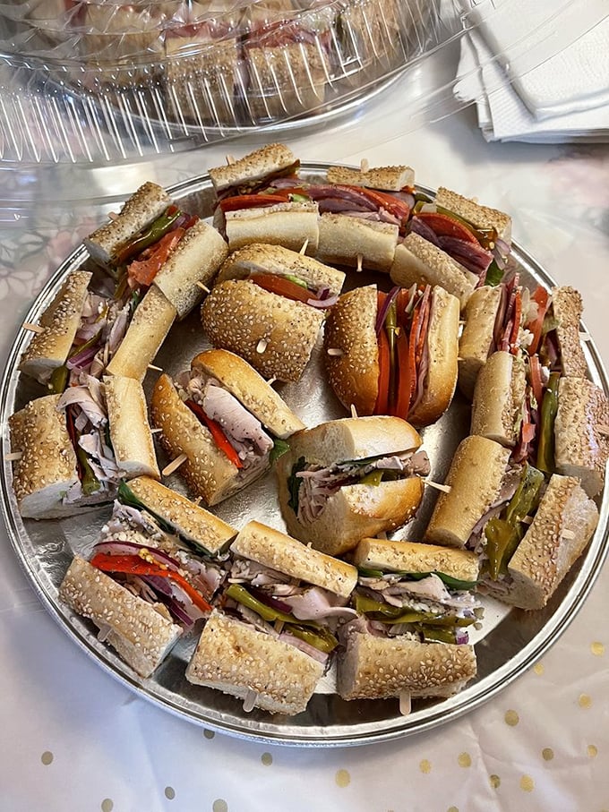 A platter of sandwich perfection—each segment a miniature masterpiece of meat, cheese, and vegetables arranged with mathematical precision that would impress Einstein.