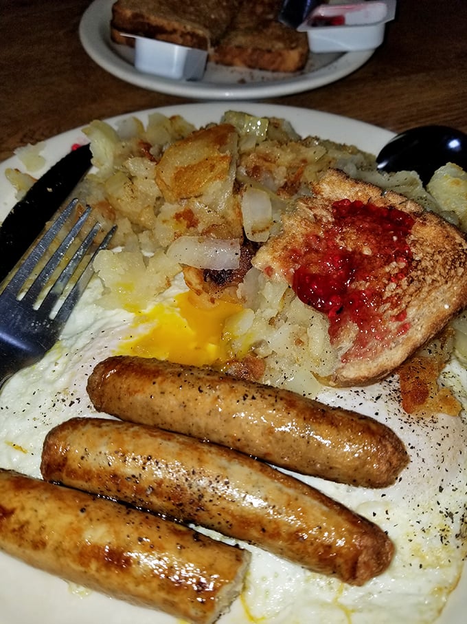 Breakfast perfection on a plate: golden home fries, perfectly cooked eggs, and sausages that snap with each bite. Morning glory, indeed.