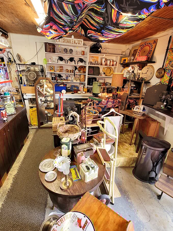 Organized chaos is the name of the game in this vendor's stall, where mid-century treasures mingle with folk art under a psychedelic fabric ceiling.