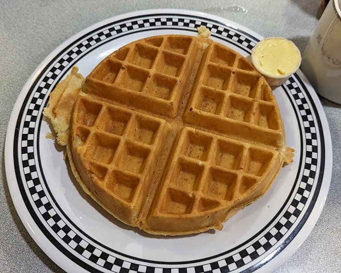 The waffle's deep pockets aren't just architectural beauty – they're strategic maple syrup reservoirs for maximum flavor in every bite.