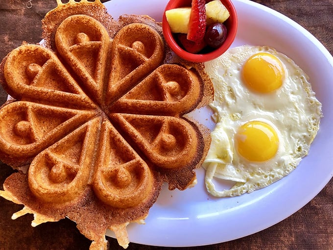 This isn't just any waffle – it's a flower-shaped masterpiece of crispy exterior and fluffy interior. Paired with perfect eggs, it's breakfast artistry.