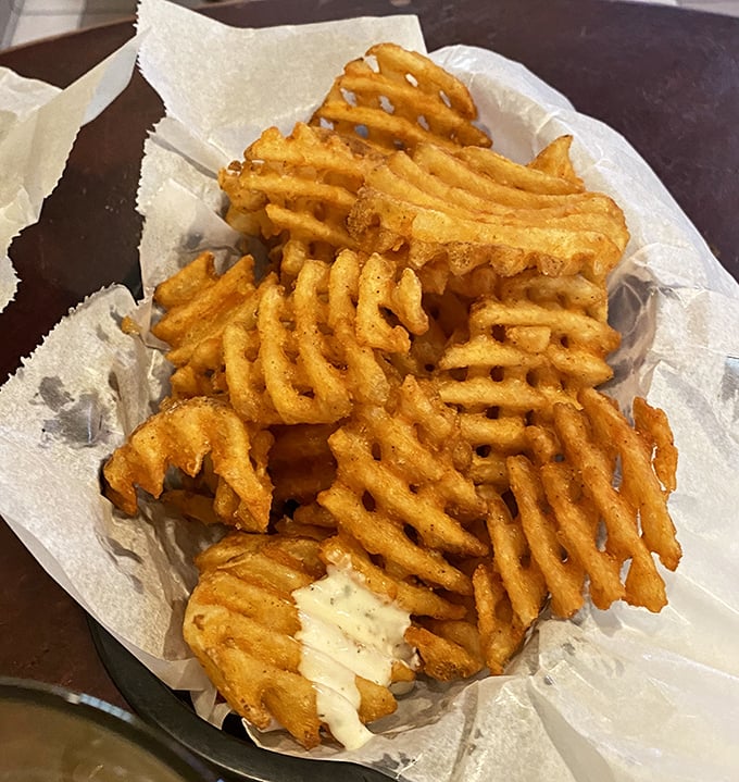 Not just any waffle fries – these golden, latticed beauties are seasoned to perfection, creating the ideal vehicle for house-made dipping sauces.