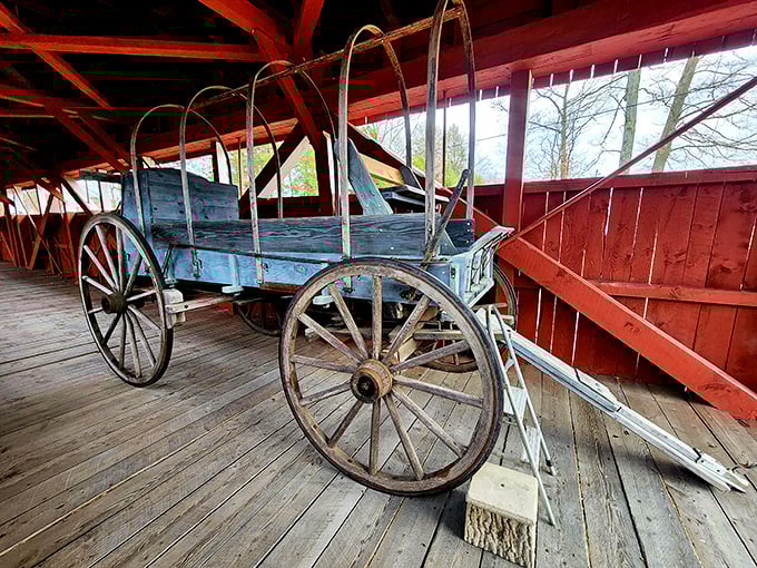 Not just a pretty face! This antique wagon display inside the bridge offers a tangible connection to the horse-drawn era that first traversed these wooden planks.