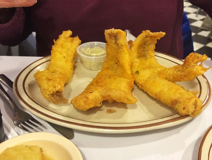 Golden-battered walleye stands at attention, ready to dive into the pool of tartar sauce—Friday's all-you-can-eat special that locals plan their week around.