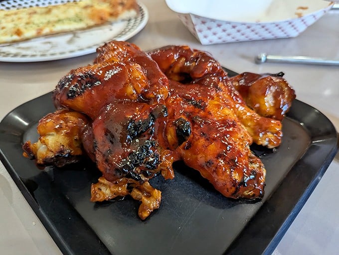 These aren't your average sports bar wings. Caramelized, charred, and glistening with sauce—they've clearly been introduced to fire the proper way.