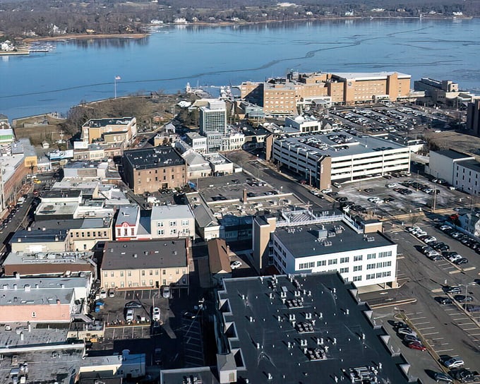 From above, Red Bank reveals its perfect positioning—a compact downtown nestled against the shimmering Navesink, with parking lots that somehow look artistic.