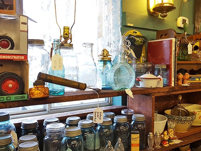 Blue glass bottles catch the light like liquid sapphires. Mason jars that once preserved summer's bounty now preserve memories of grandma's kitchen.