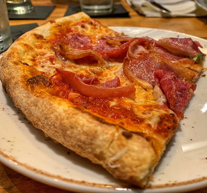 This isn't just pizza—it's a canvas where prosciutto and red sauce create an edible masterpiece that would make Michelangelo weep.