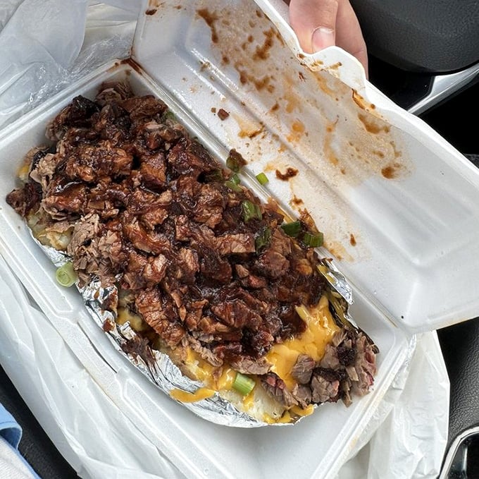 The loaded baked potato—where chopped brisket finds its perfect home atop melted cheese. Comfort food having a promotion party.