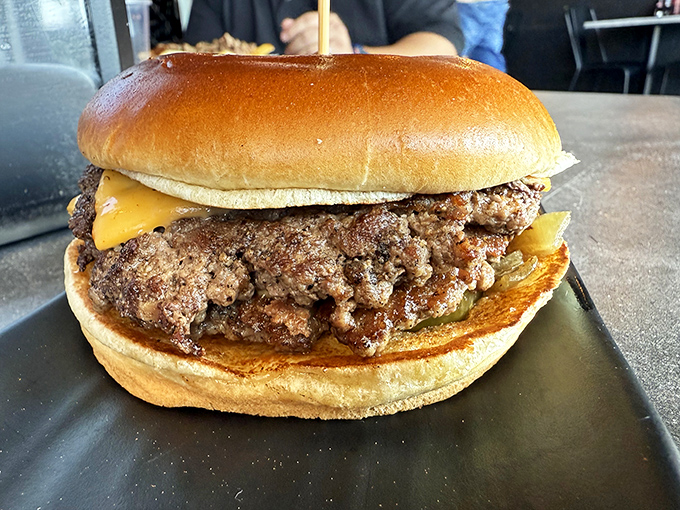 Behold the star of the show – a burger patty with the perfect sear and just enough cheese to make you contemplate a second order.