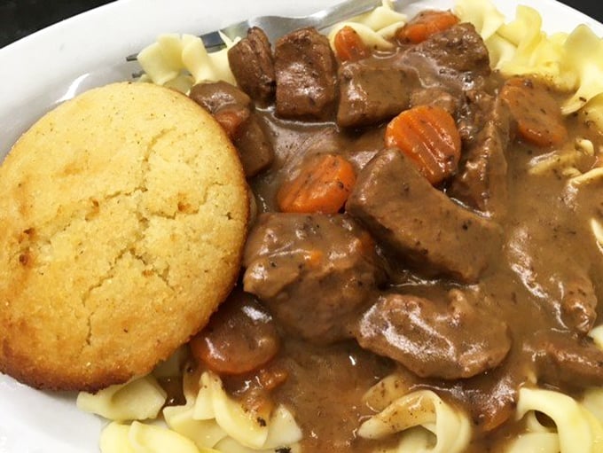 Beef tips and gravy over noodles with a perfect cornbread sidekick. This plate doesn't just feed your body—it hugs your soul and whispers, "Everything's gonna be alright."