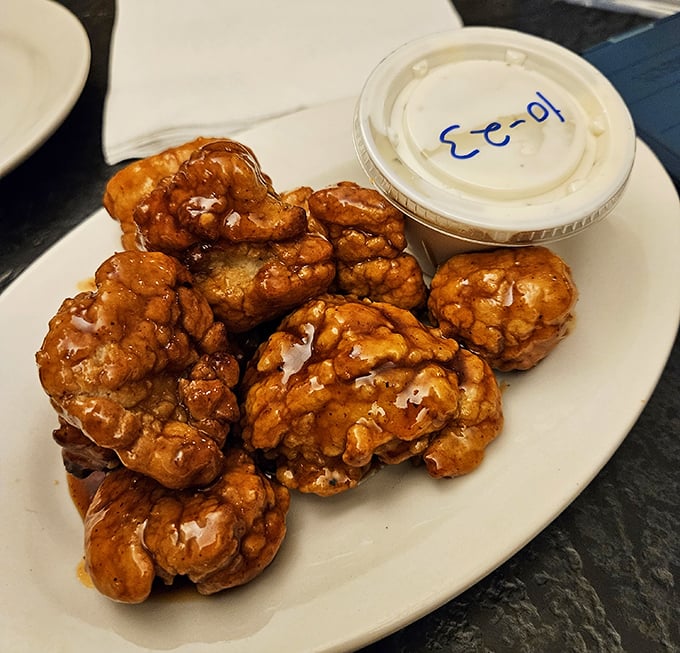 These boneless wings aren't just chicken nuggets with delusions of grandeur—they're sticky, sweet flavor bombs that demand a stack of napkins and zero shame.