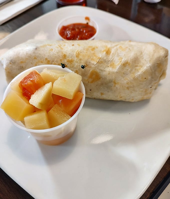 This breakfast burrito doesn't just start your day—it launches it into orbit, with fresh fruit on the side to maintain the illusion of virtue.