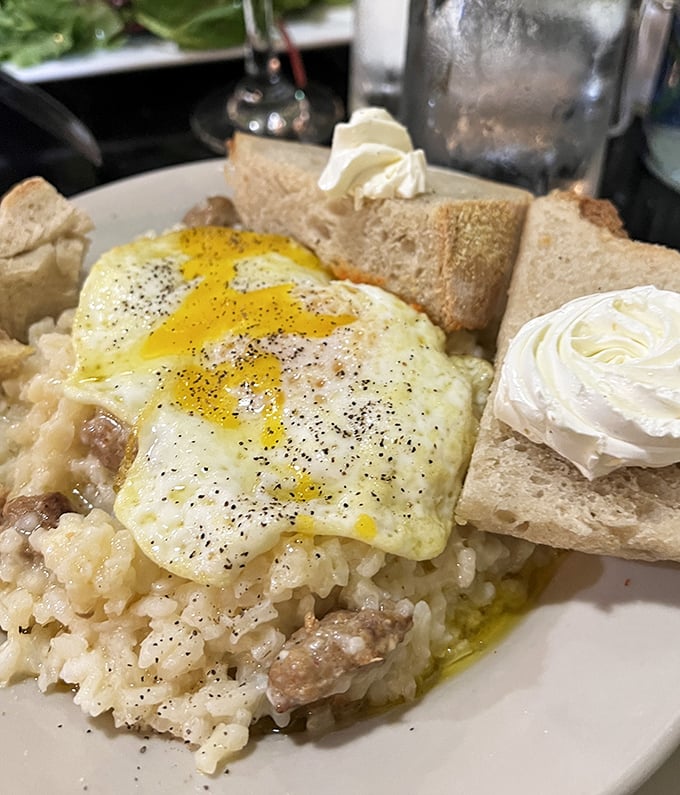 The breakfast that launched a thousand road trips. Creamy Parmesan risotto crowned with a perfectly fried egg—worth setting your alarm for, even on weekends.
