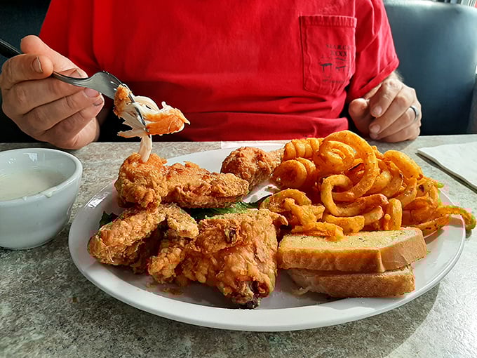 The broasted chicken arrives like the headliner of a sold-out show—golden, crispy, and ready for its standing ovation. Those curly fries aren't just sidekicks.