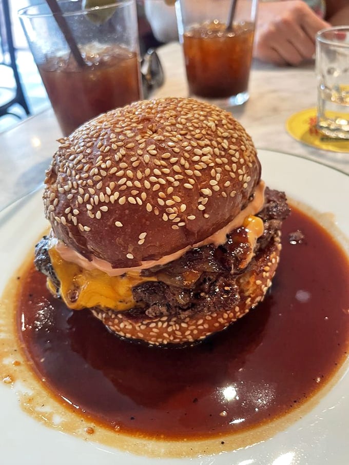 A burger swimming in savory jus with melted cheese cascading down the sides. This isn't just breaking diet rules—it's setting the rulebook on fire and dancing around the flames.