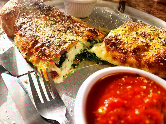 The calzone at Big PaPa's isn't just a meal—it's an event. Molten cheese stretches dramatically with each bite, demanding both your attention and your appetite.