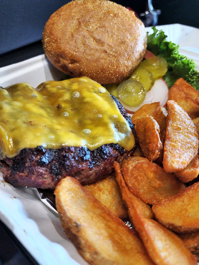 A burger that means business. Melted cheese cascades over a perfectly charred patty, proving that simple pleasures are often the most satisfying.