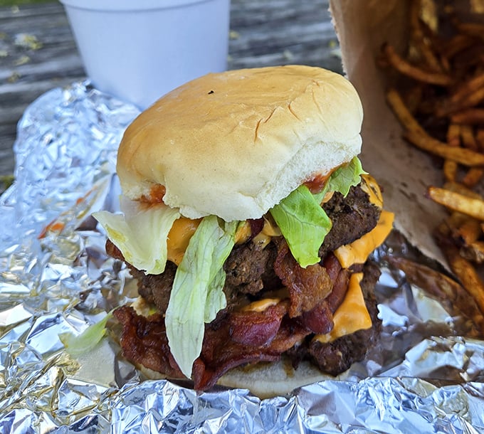 Behold the architectural marvel that is a proper Ohio burger—layers of beef, bacon, and cheese creating a savory skyscraper that demands both hands and commitment.