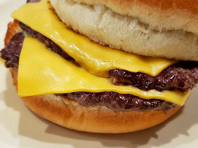 This isn't just a cheeseburger; it's a masterclass in American simplicity – perfectly melted cheese embracing a hand-formed patty like an old friend.