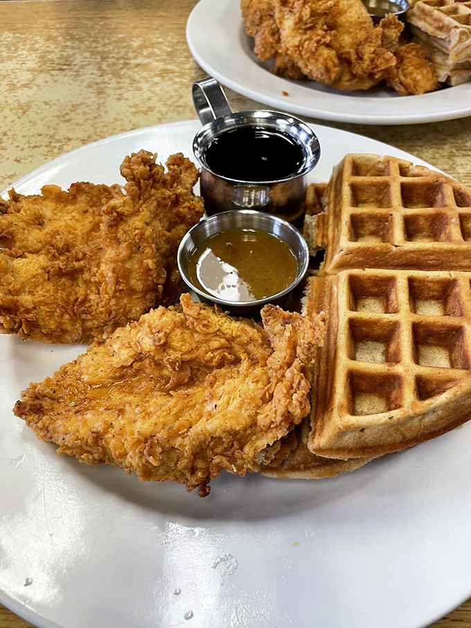 The legendary chicken and waffles, where savory meets sweet in perfect harmony. Two sauces for dipping? That's not indulgence—that's just good sense.