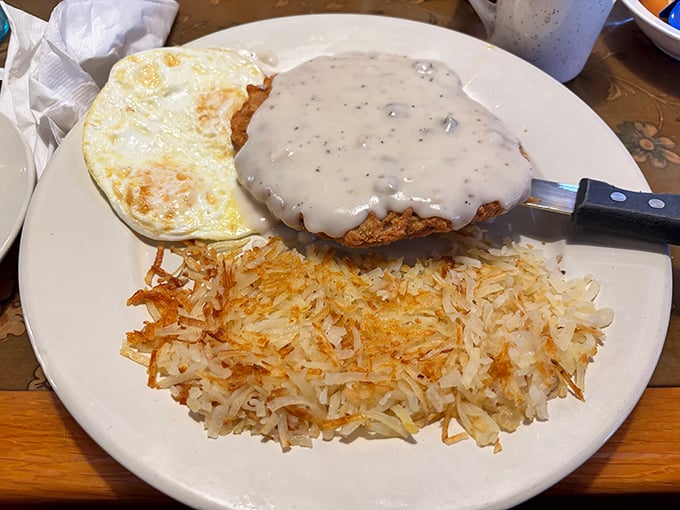 The chicken fried steak—a masterclass in crispy-meets-tender perfection, smothered in gravy that should be declared a national treasure.