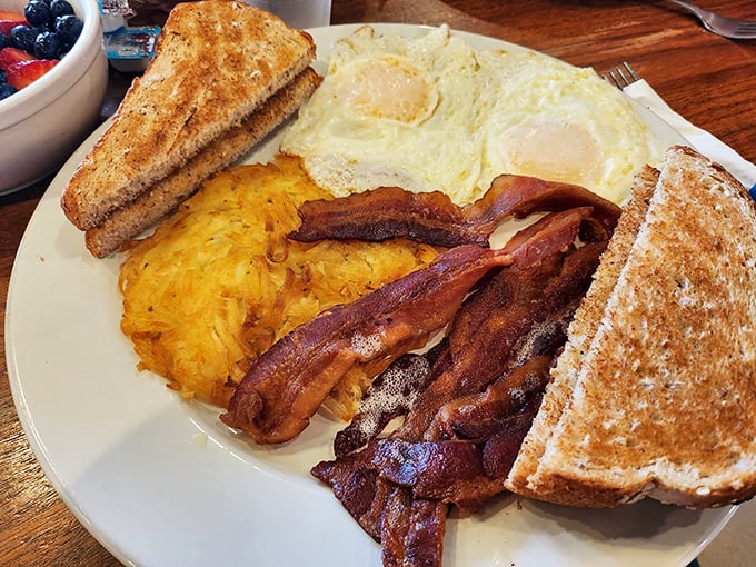 The classic breakfast plate—where eggs, bacon, and toast perform their timeless morning symphony. Comfort food that speaks a universal language.