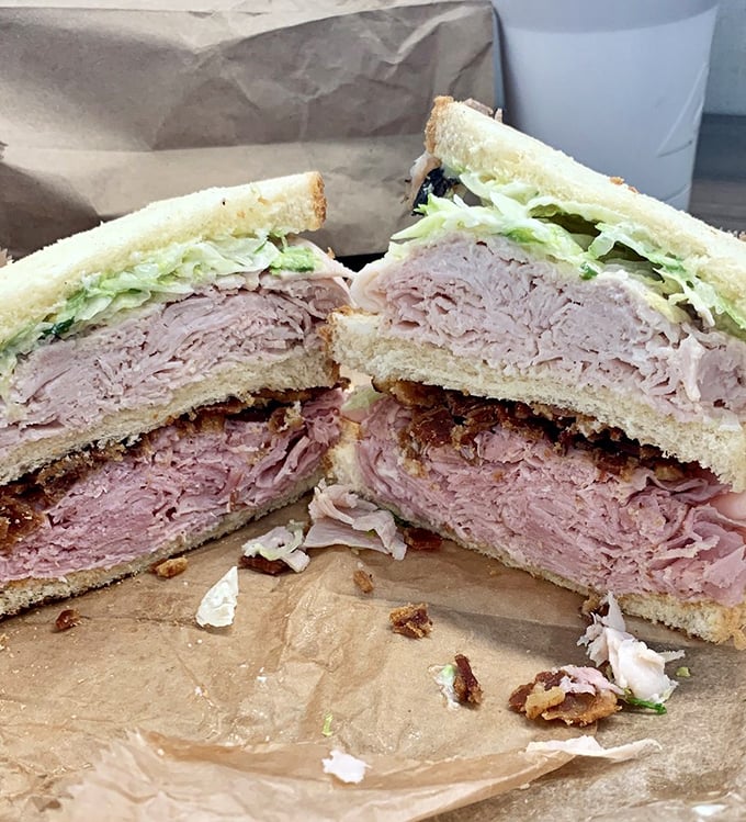The club sandwich that requires a game plan to eat. Three layers of bread creating the perfect meat-to-veggie ratio—a skyscraper of satisfaction.