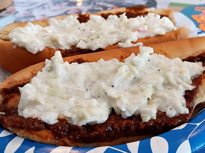 Coleslaw and chili create a yin-yang of textures atop these dogs – cool, creamy slaw balancing the warm, savory chili in perfect harmony.