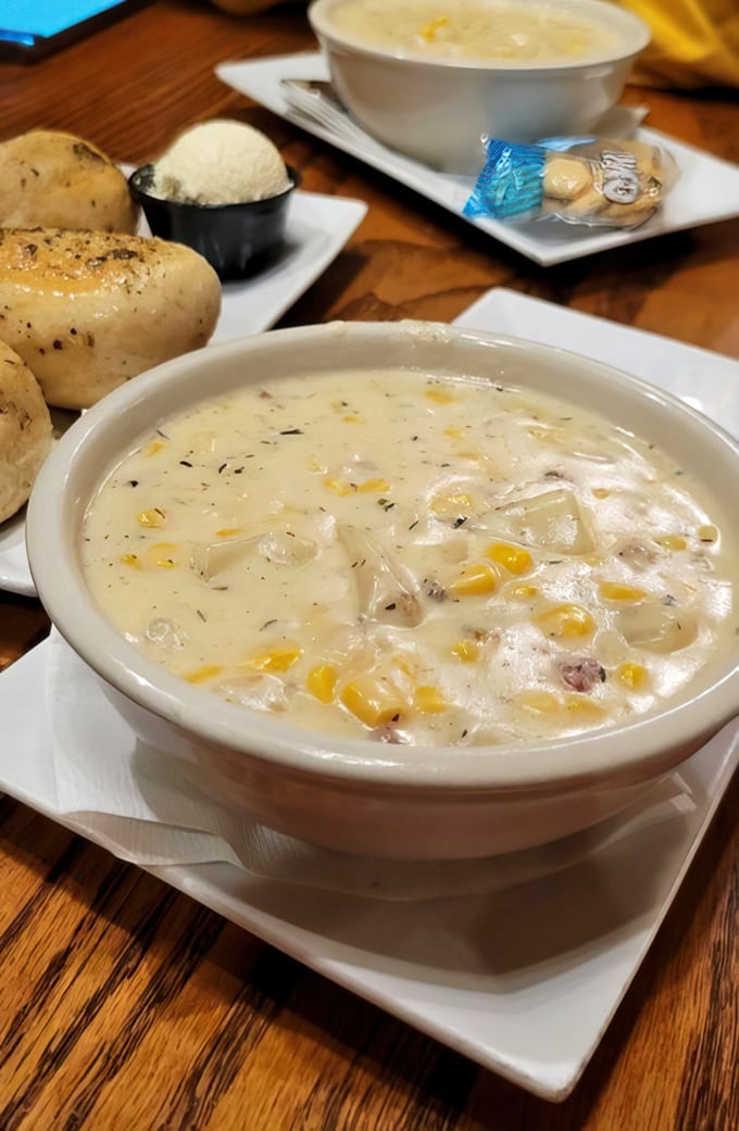 Creamy corn chowder that warms the soul like a campfire tale, served with fresh-baked rolls that would make any pioneer proud.