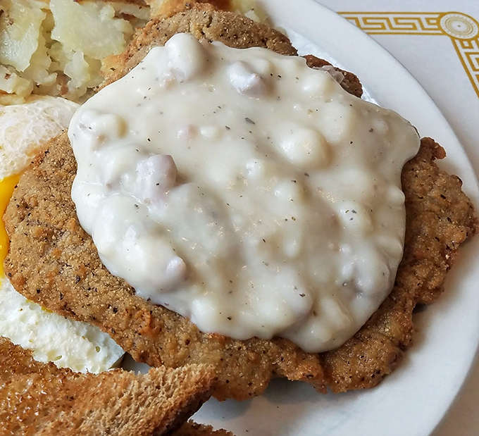 Country fried steak smothered in gravy – where the phrase "knife and fork optional" becomes "nap afterward mandatory."