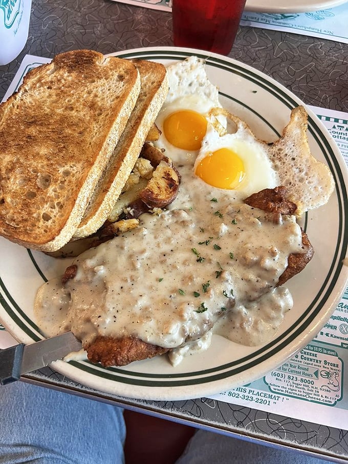 The holy grail of diner cuisine—country-fried steak smothered in peppery white gravy, with sunny-side-up eggs and toast standing by for gravy-sopping duty.