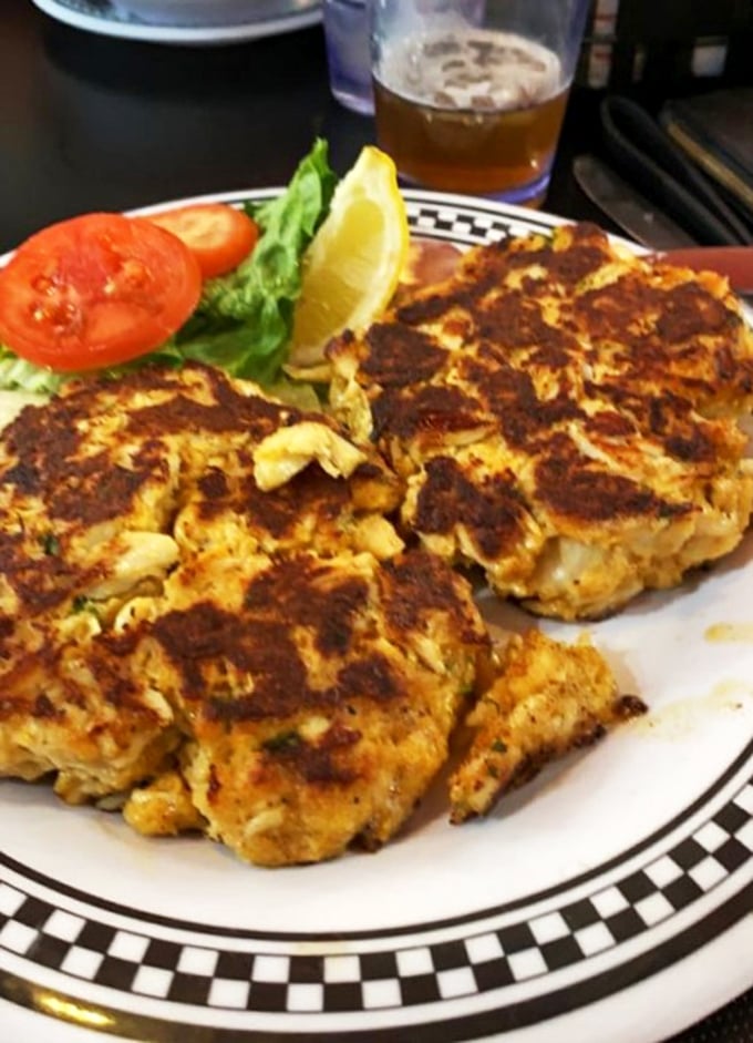 Maryland's culinary religion on a plate – these golden-brown crab cakes contain more jumbo lump meat than most relationships contain commitment.
