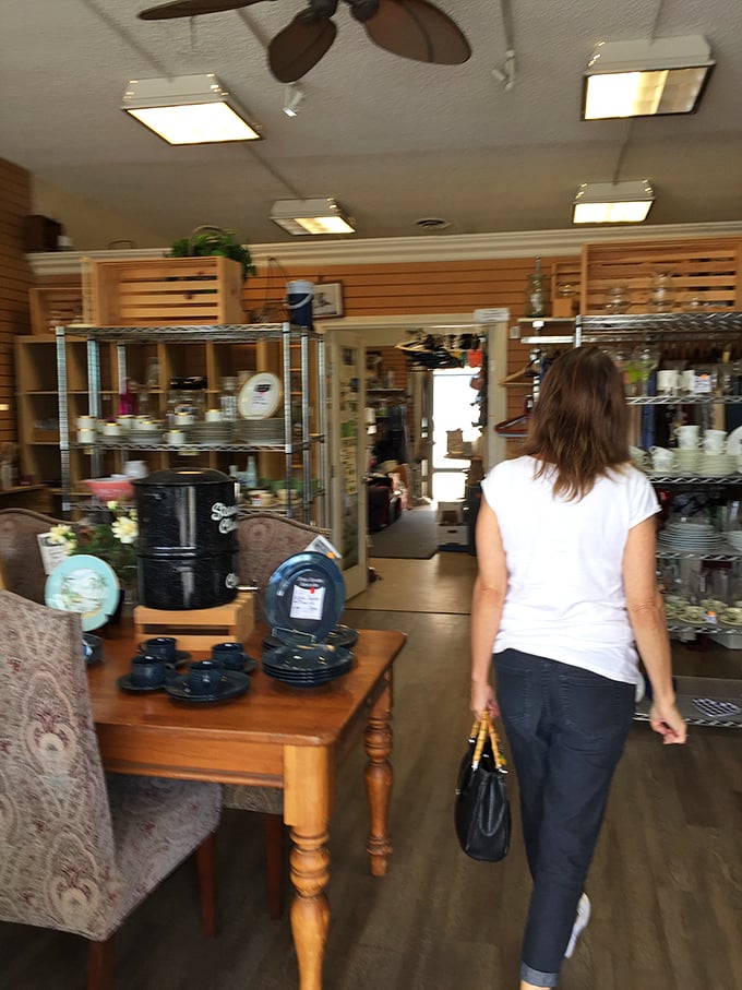 The journey through thrift wonderland continues as shoppers navigate aisles of hidden gems. Every turn reveals new potential treasures.