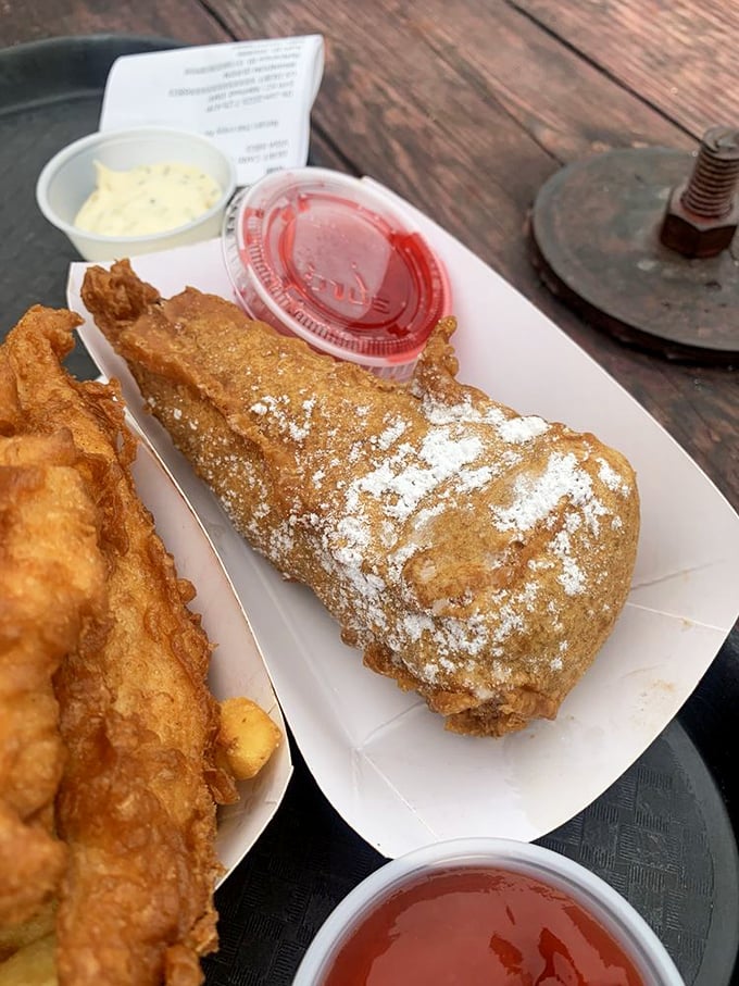 Powdered sugar dusting a golden-fried treasure like the first snow on a California beach—this deep-fried cheesecake defies all diet resolutions.